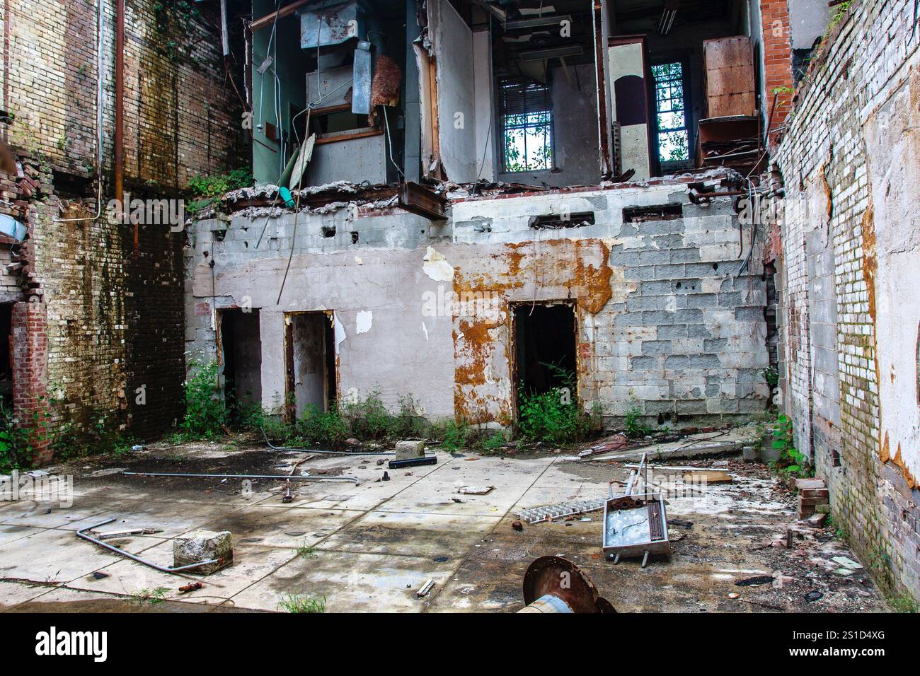 Dilapidated interior of an old building with exposed walls, debris, and ...