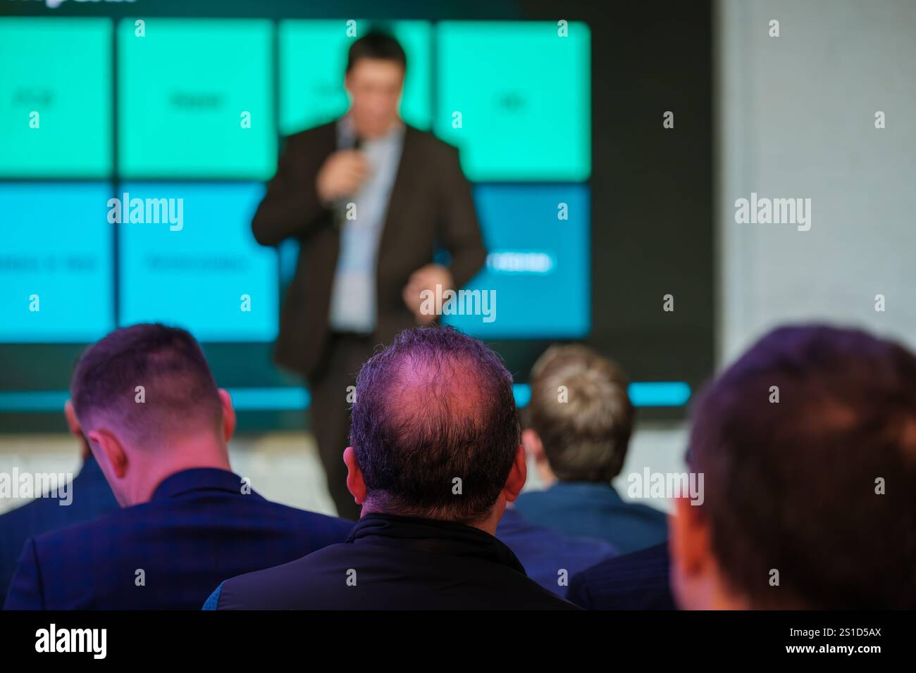 Speaker engages audience with presentation at business conference ...