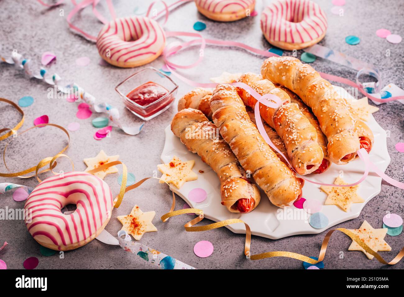 Long sausages wrapped in yeast dough with donuts - traditional carnival ...