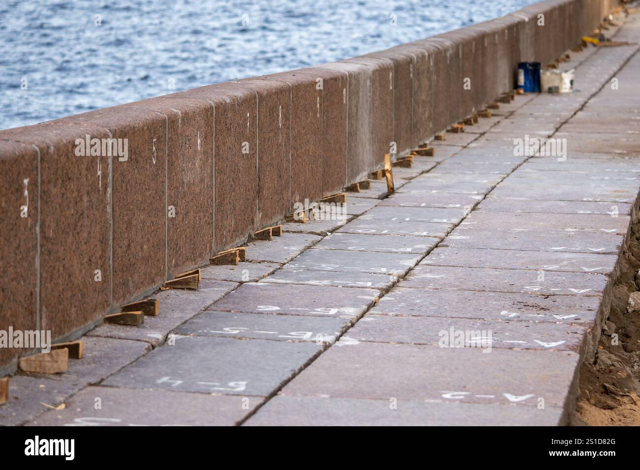 Embankment repair on Neva river strengthens and aligns granite slabs ...