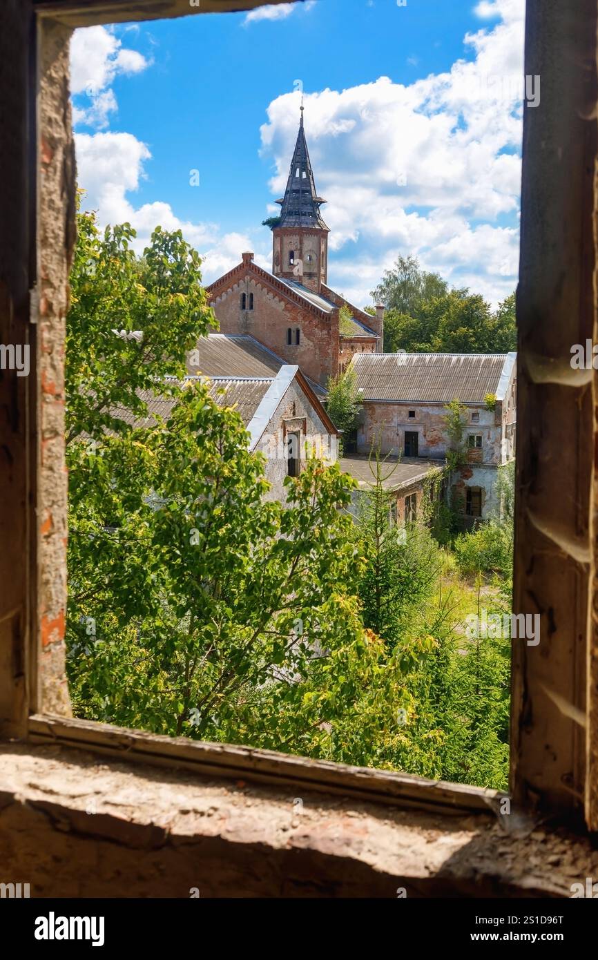 View of the old abandoned Catholic Church overgrown with greenery and ...