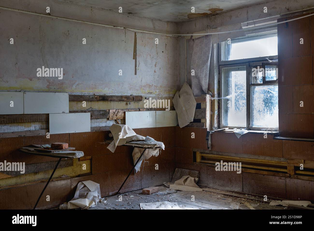 Interior of a living room with broken window of an old abandoned house ...