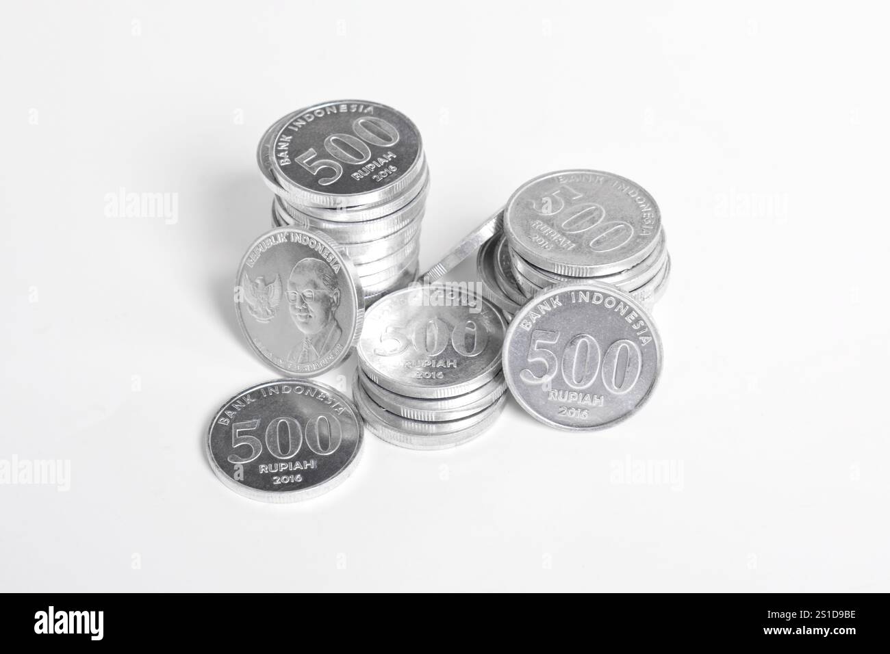 Silver coins stacks isolated on a white background. Indonesian rupiah ...