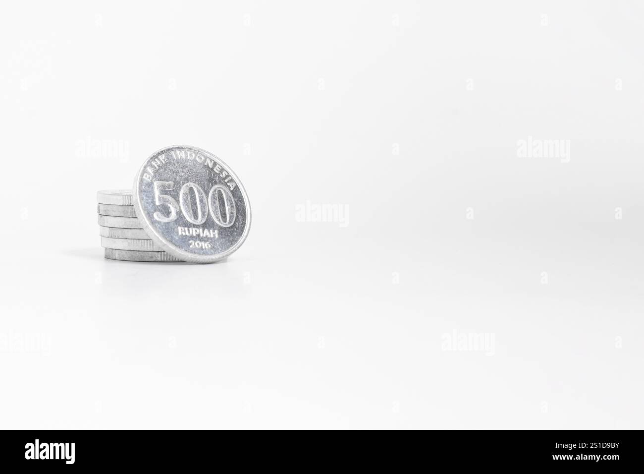 Silver coins stacks isolated on a white background. Indonesian rupiah ...