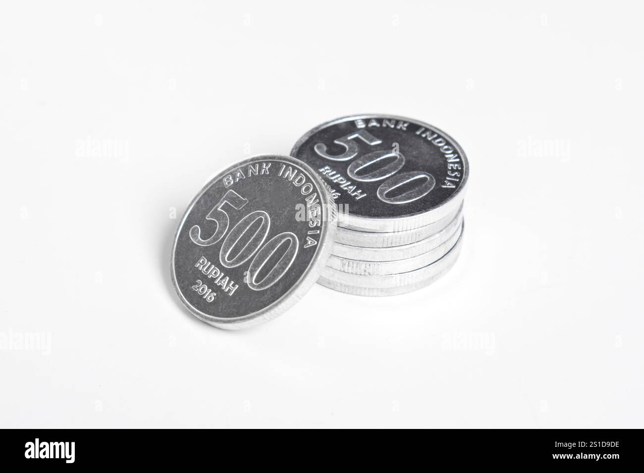 Silver coins stacks isolated on a white background. Indonesian rupiah ...