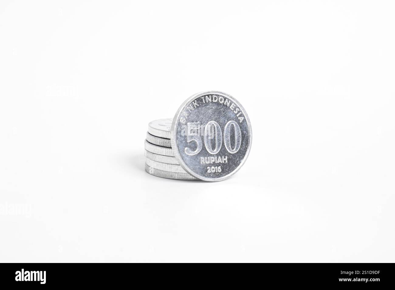 Silver coins stacks isolated on a white background. Indonesian rupiah ...