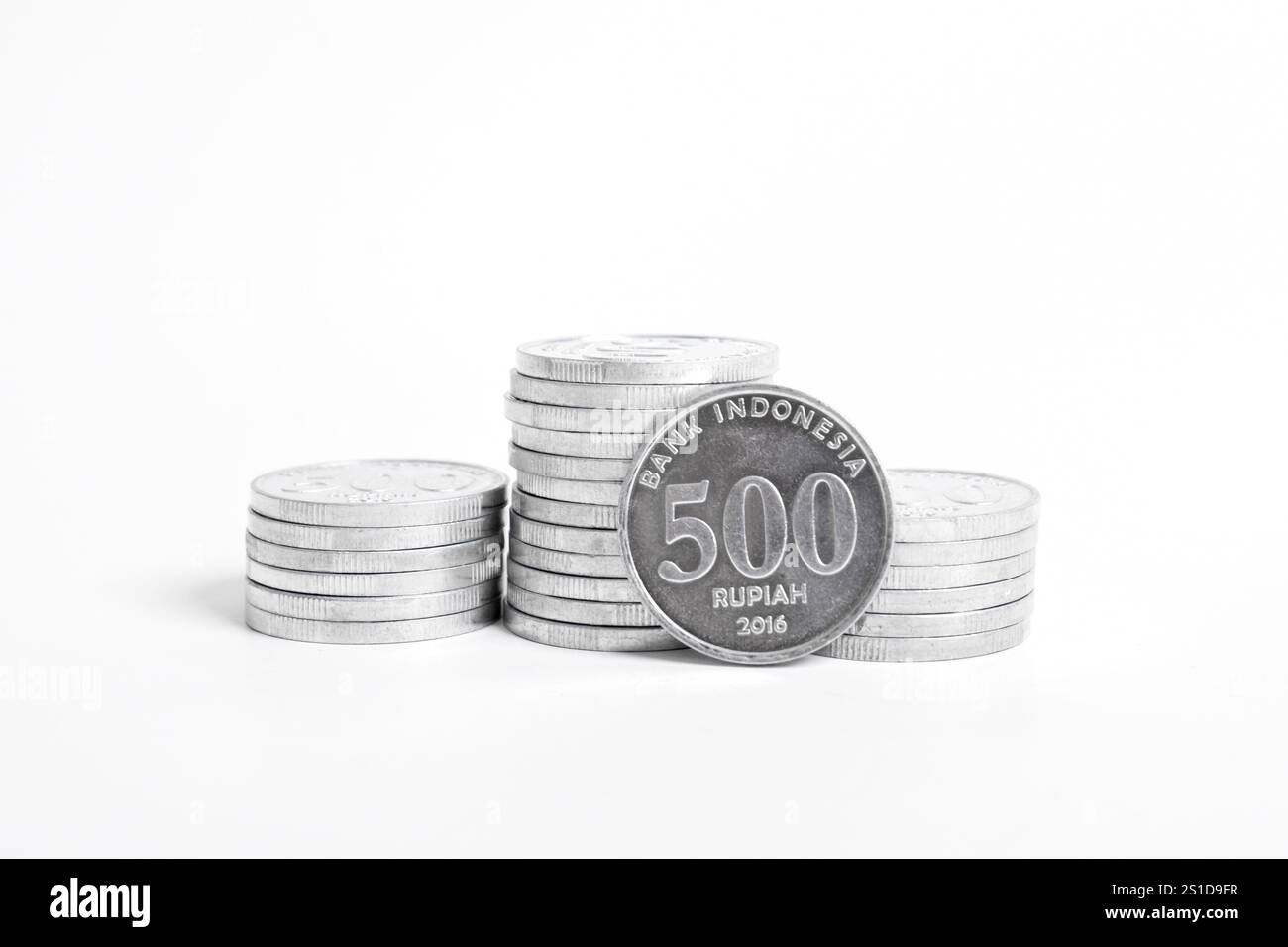 Silver coins stacks isolated on a white background. Indonesian rupiah ...