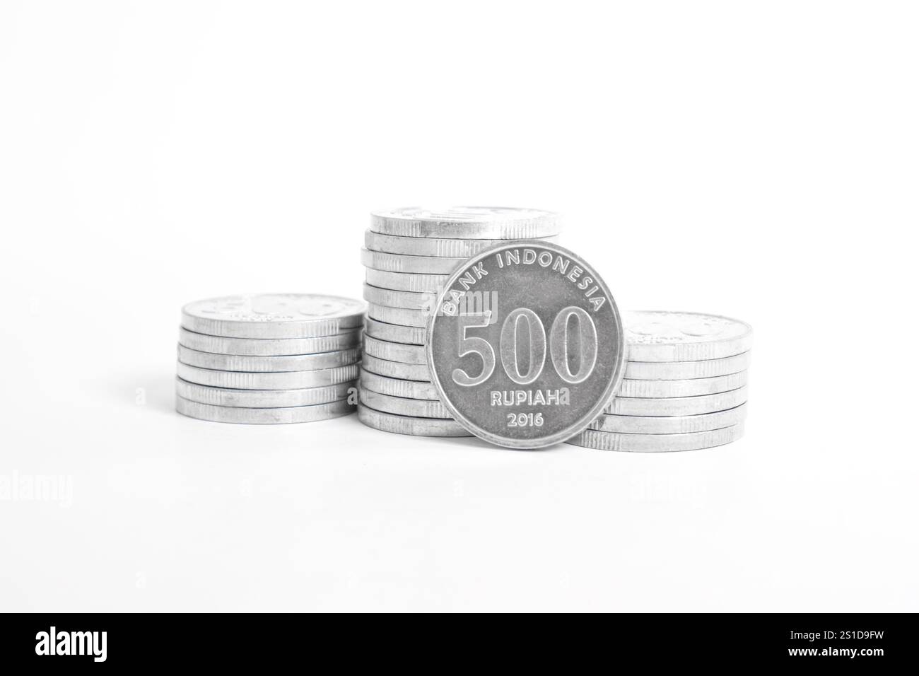 Silver coins stacks isolated on a white background. Indonesian rupiah ...