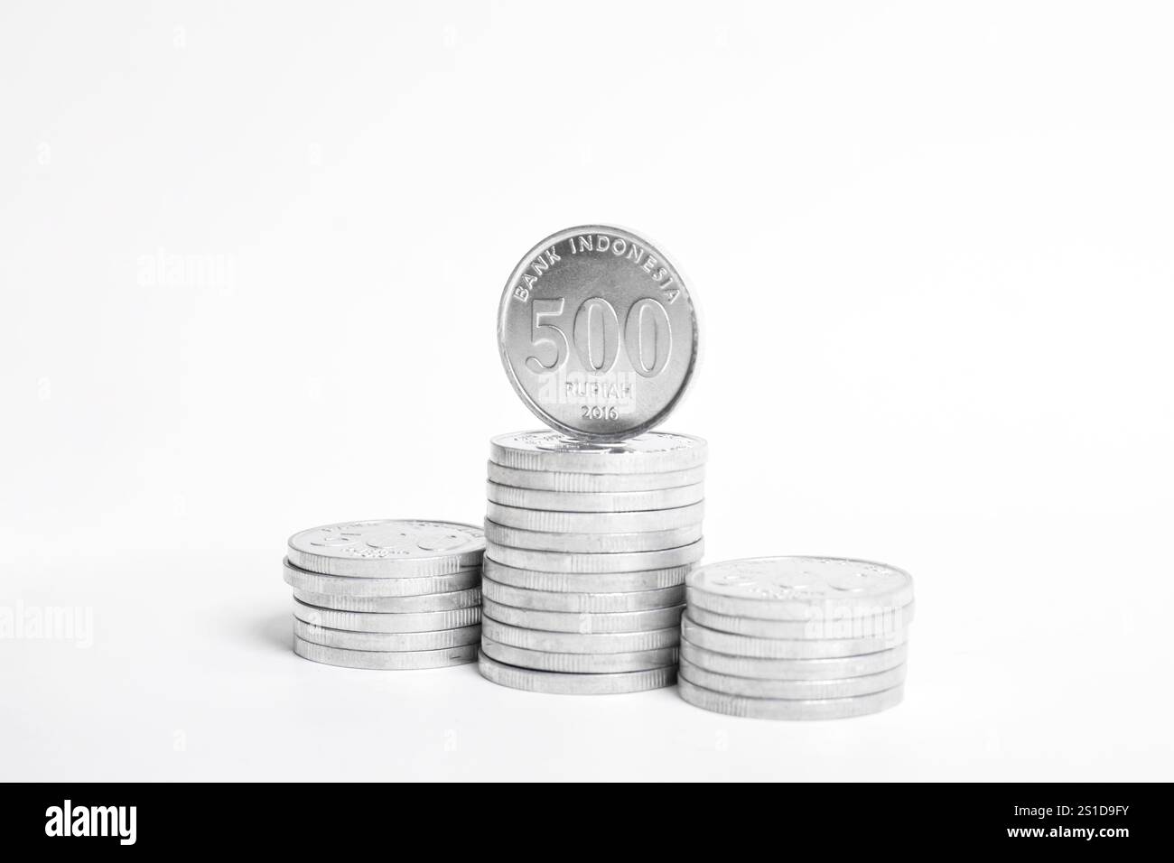 Silver coins stacks isolated on a white background. Indonesian rupiah ...