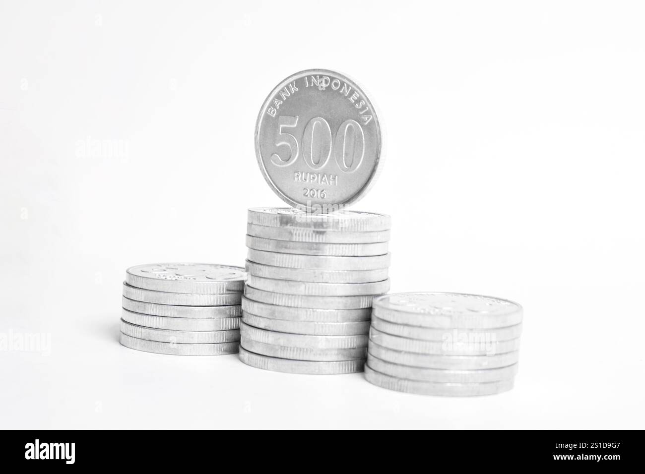 Silver coins stacks isolated on a white background. Indonesian rupiah ...