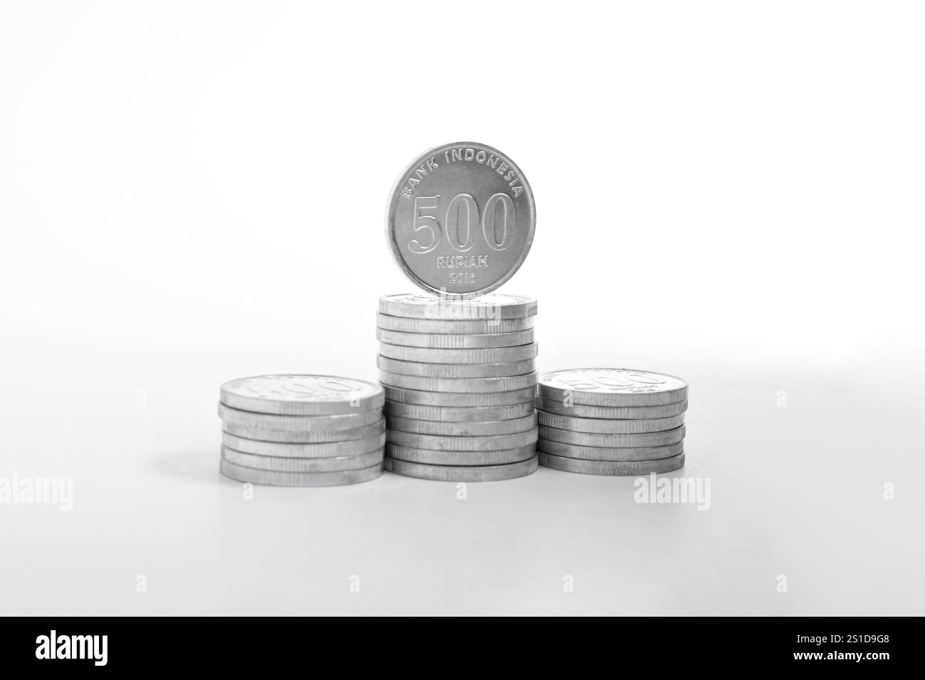 Silver coins stacks isolated on a white background. Indonesian rupiah ...