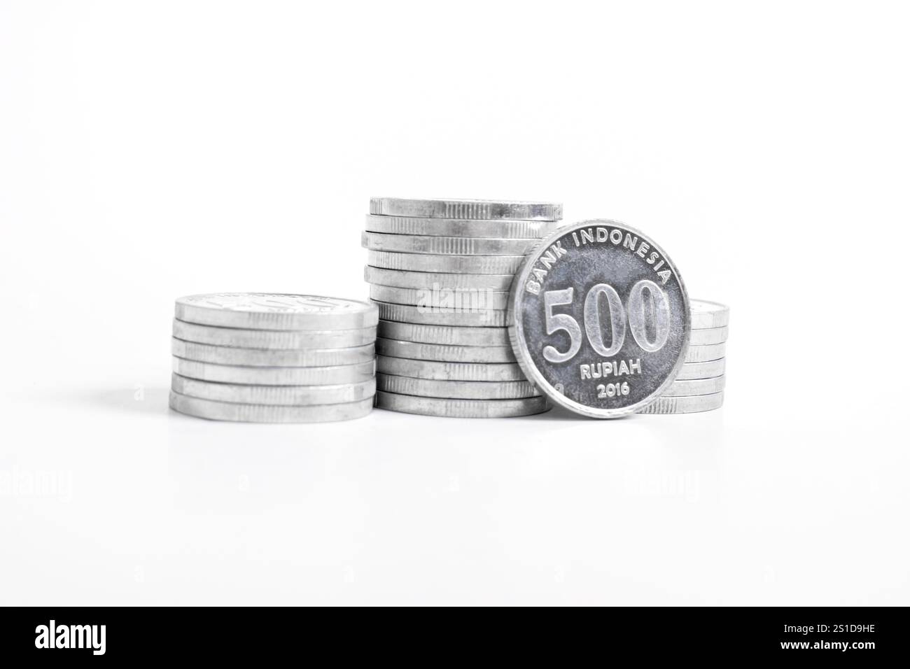 Silver coins stacks isolated on a white background. Indonesian rupiah ...