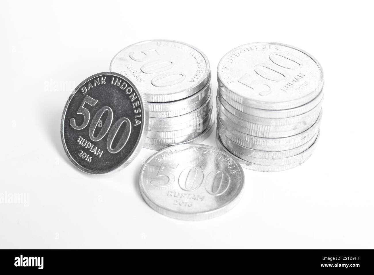 Silver coins stacks isolated on a white background. Indonesian rupiah ...