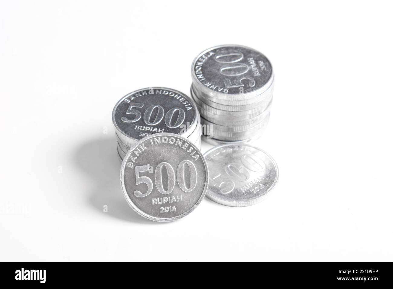 Silver coins stacks isolated on a white background. Indonesian rupiah ...