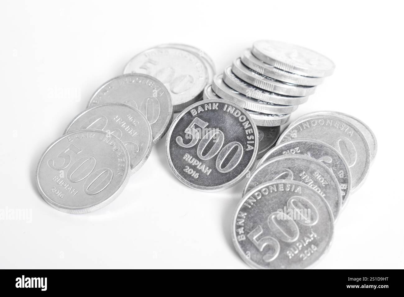 Silver coins stacks isolated on a white background. Indonesian rupiah ...