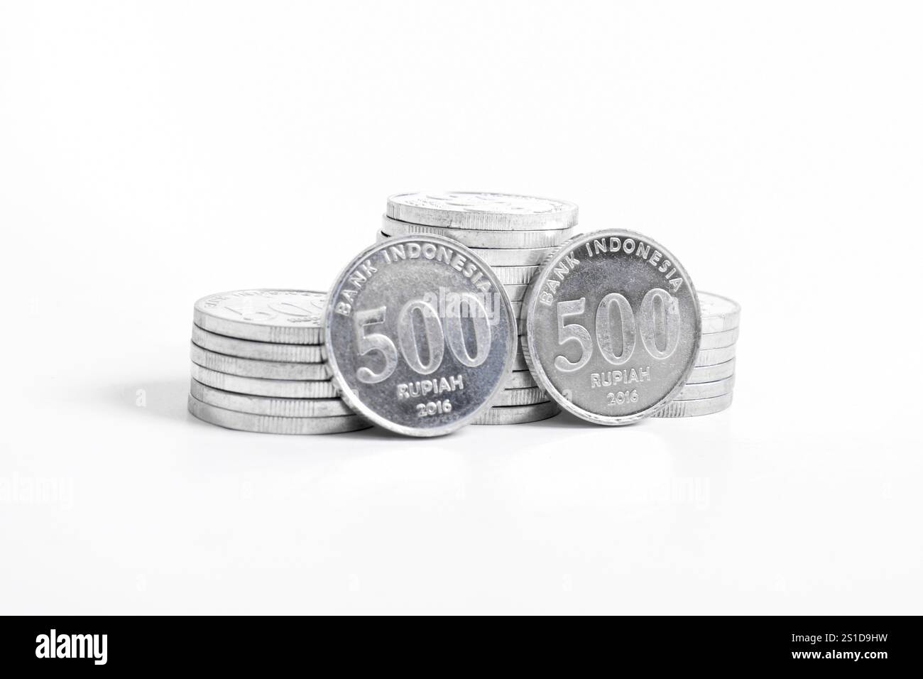 Silver coins stacks isolated on a white background. Indonesian rupiah ...