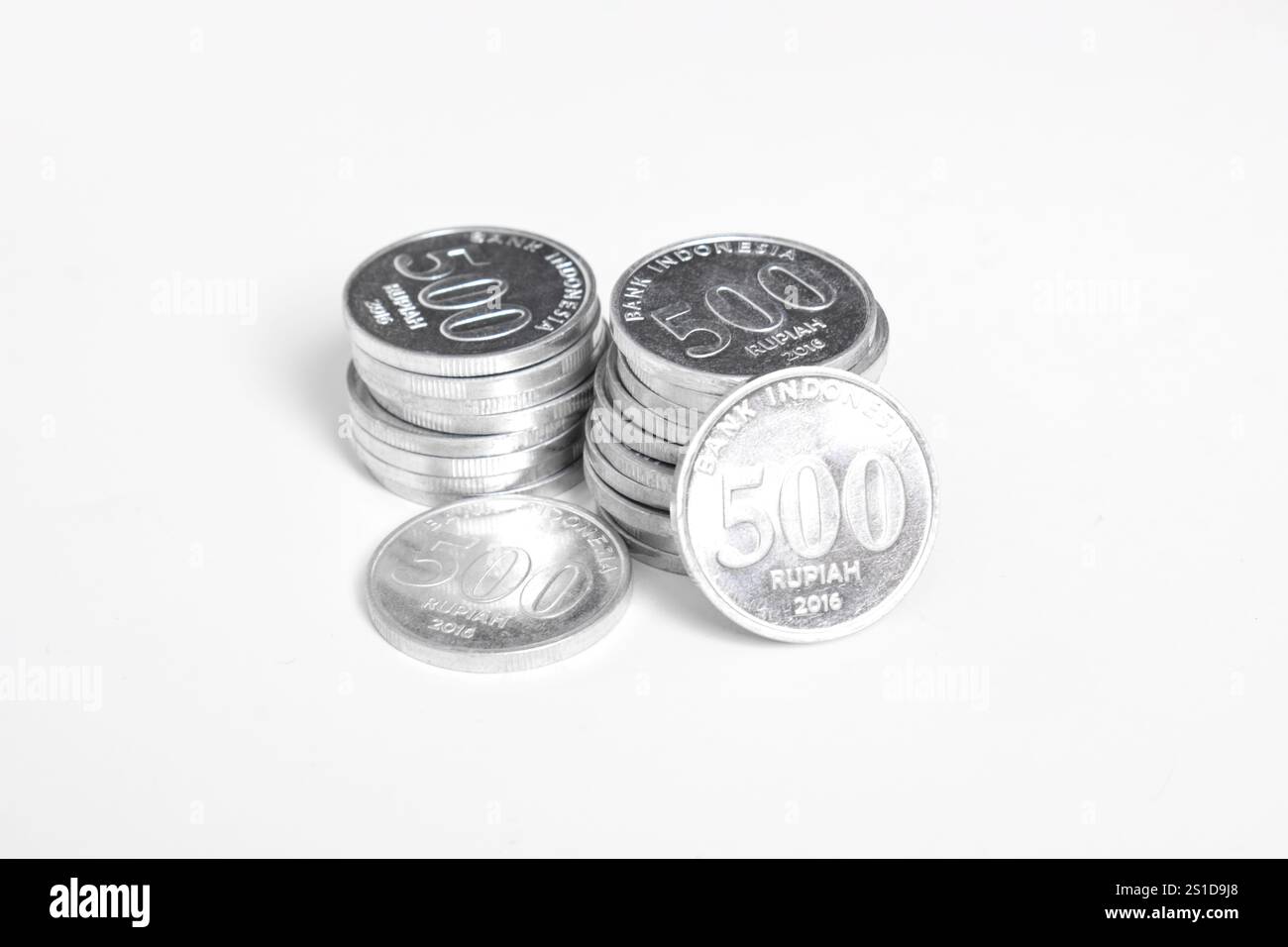 Silver coins stacks isolated on a white background. Indonesian rupiah ...