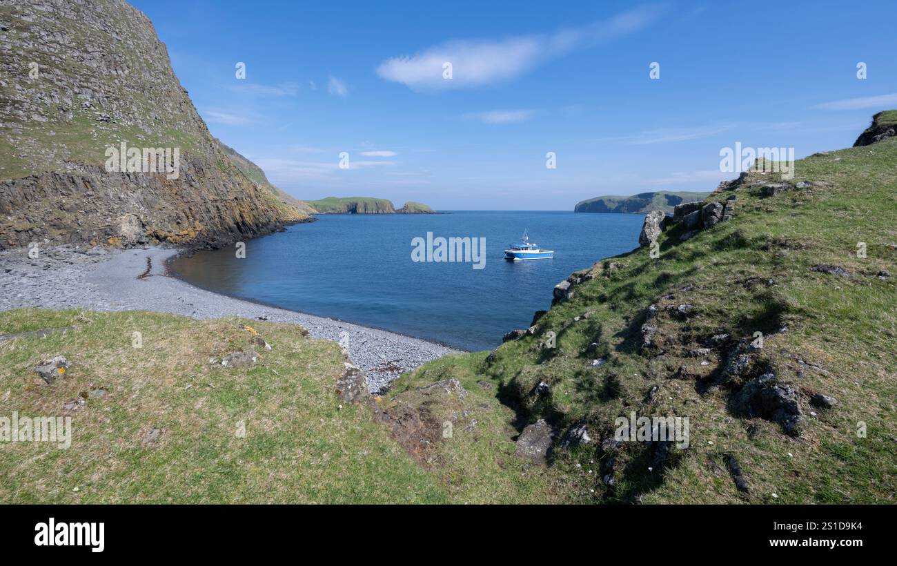 Small boat in the bay at Eilean an Taighe and Garbh Eilean, Shiant ...