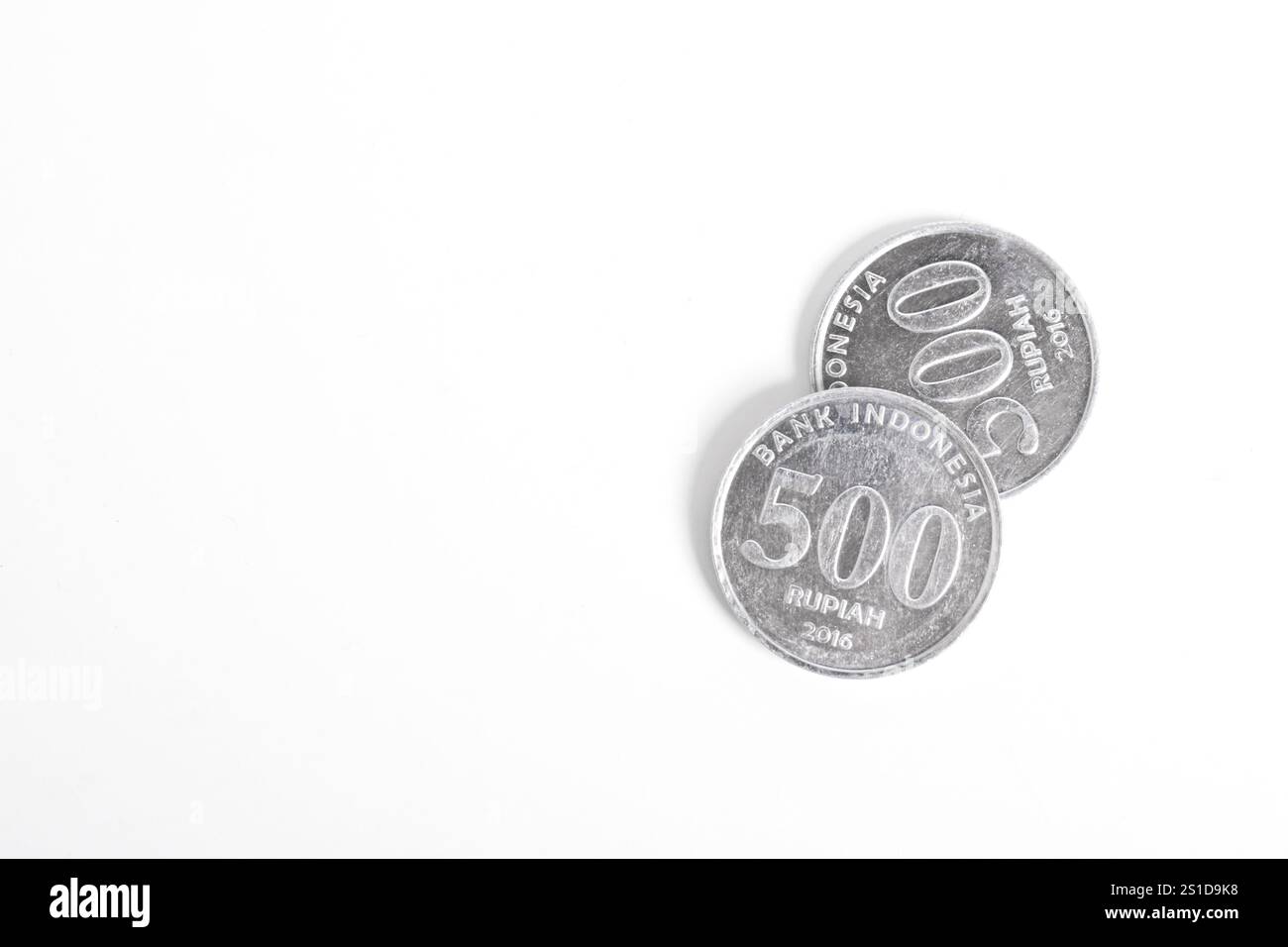 Silver coins stacks isolated on a white background. Indonesian rupiah ...