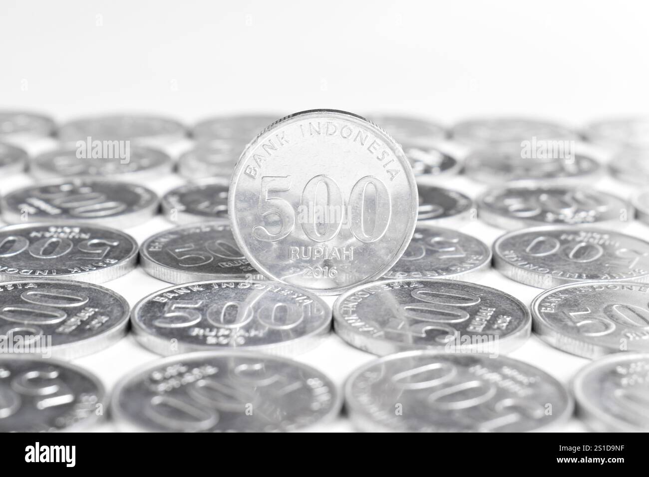 Indonesian five hundred rupiah coin standing with other coins isolated ...