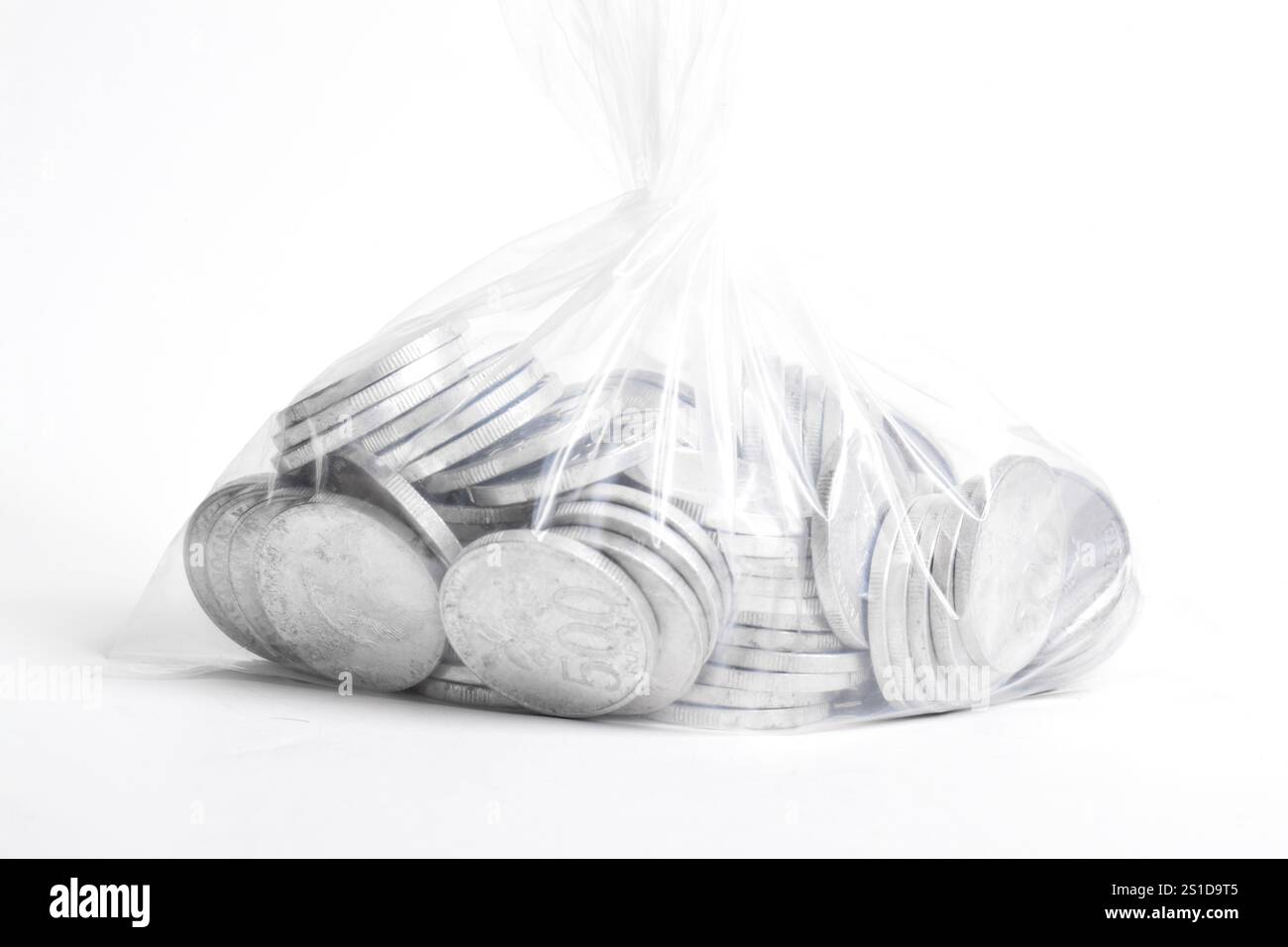 Stack of silver coins in clear plastic on white background. Coin tower ...