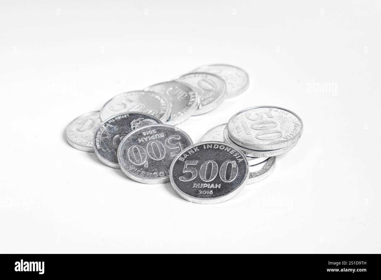 Silver coins stacks isolated on a white background. Indonesian rupiah ...