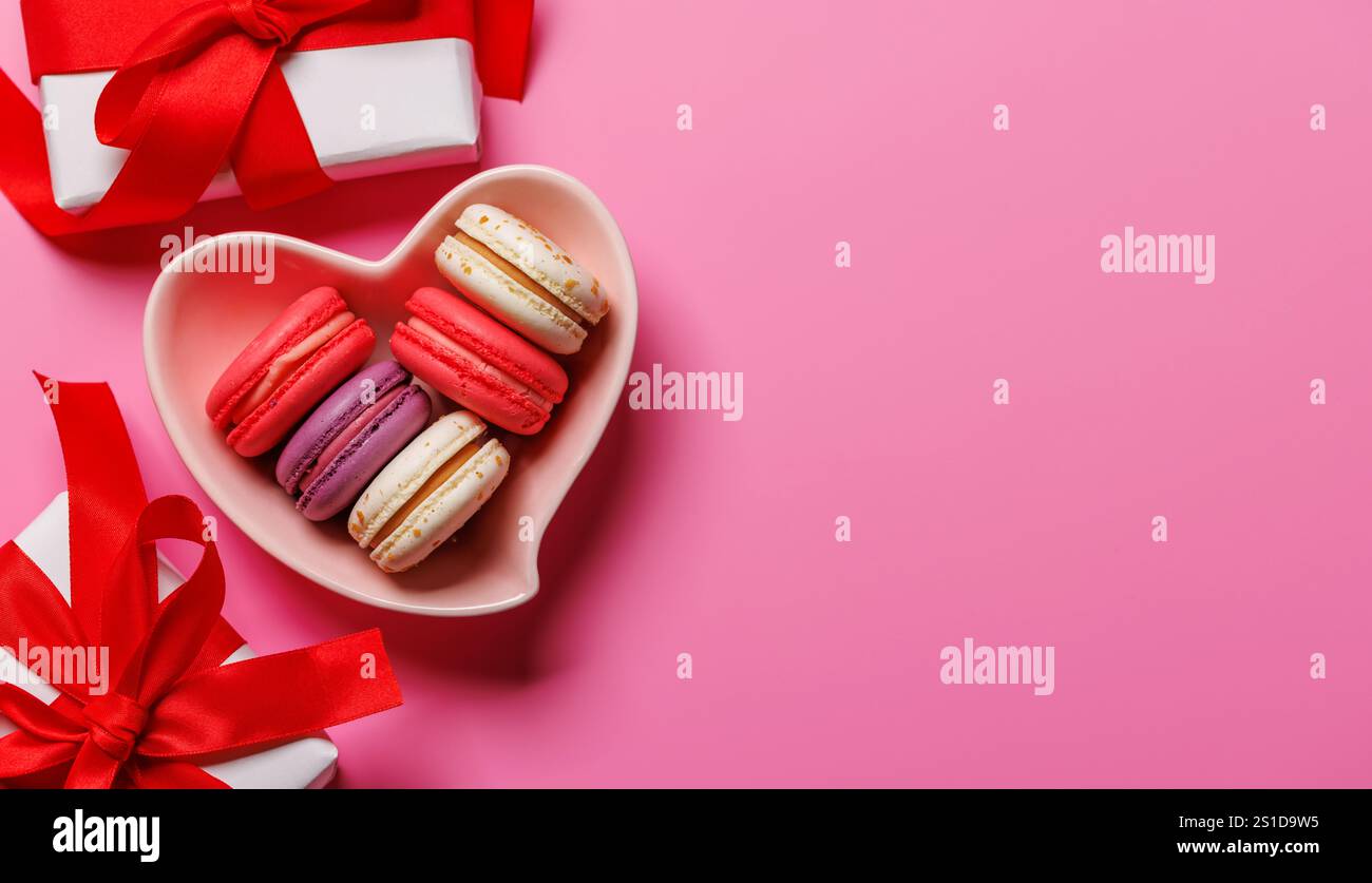 Colorful macaroons elegantly arranged in a heart-shaped bowl, paired ...
