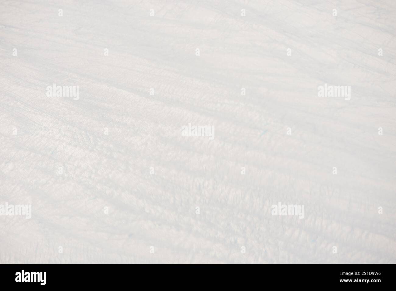 An aerial view of a glacier's flat, expansive ice surface, captured ...