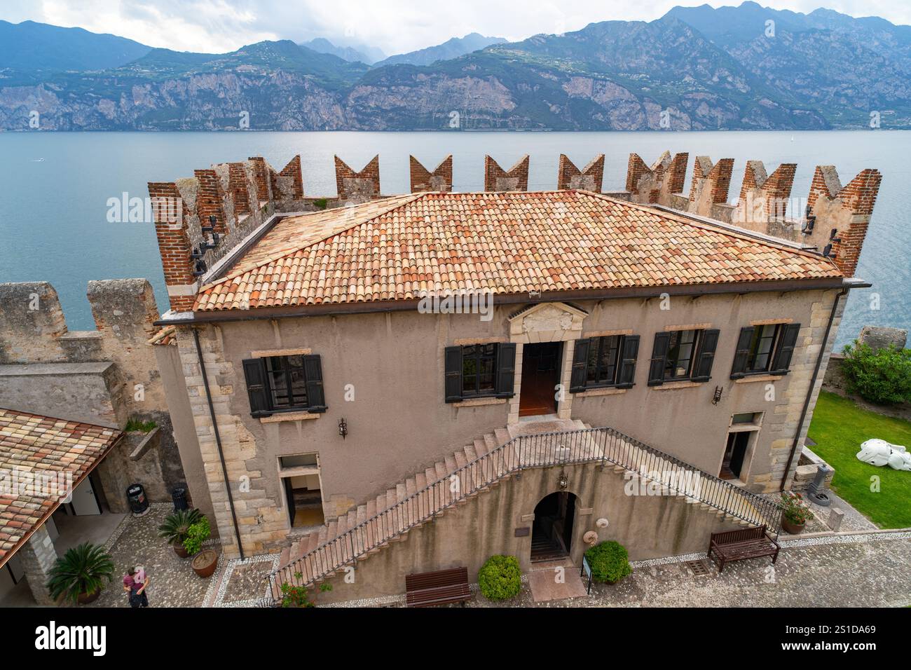 Historic castle building with terracotta roof, arched windows, and ...