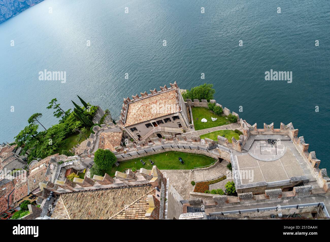 Aerial view of a historic lakeside castle with stone walls, terracotta ...