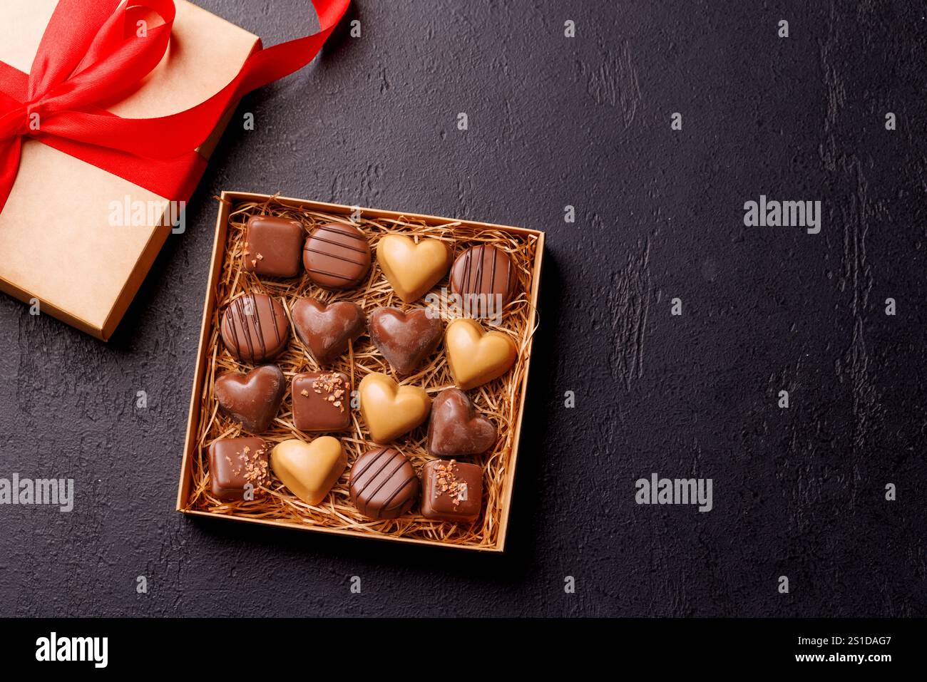 Valentines day box of rich chocolates, set against a dark backdrop ...