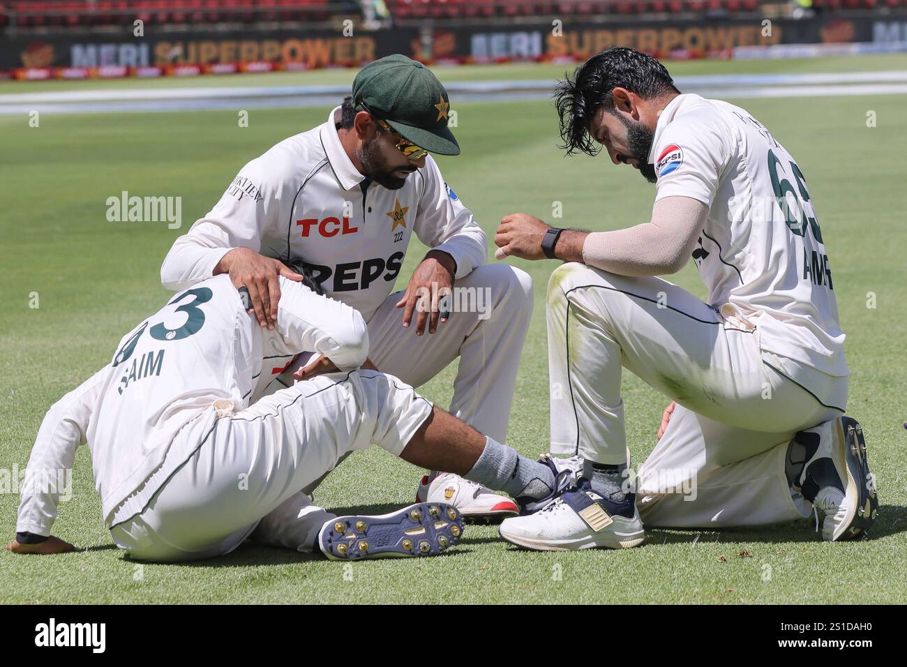Pakistan's Saim Ayub, left, injures his ankle as Babar Azam and Aamir ...
