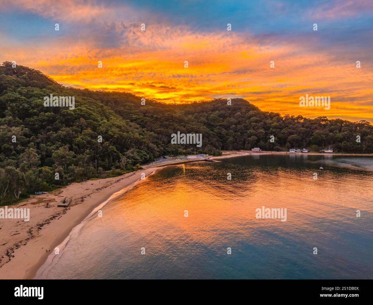 High cloud covered sunrise over Brisk Bay with boats and mountain ranges around the seaside ...