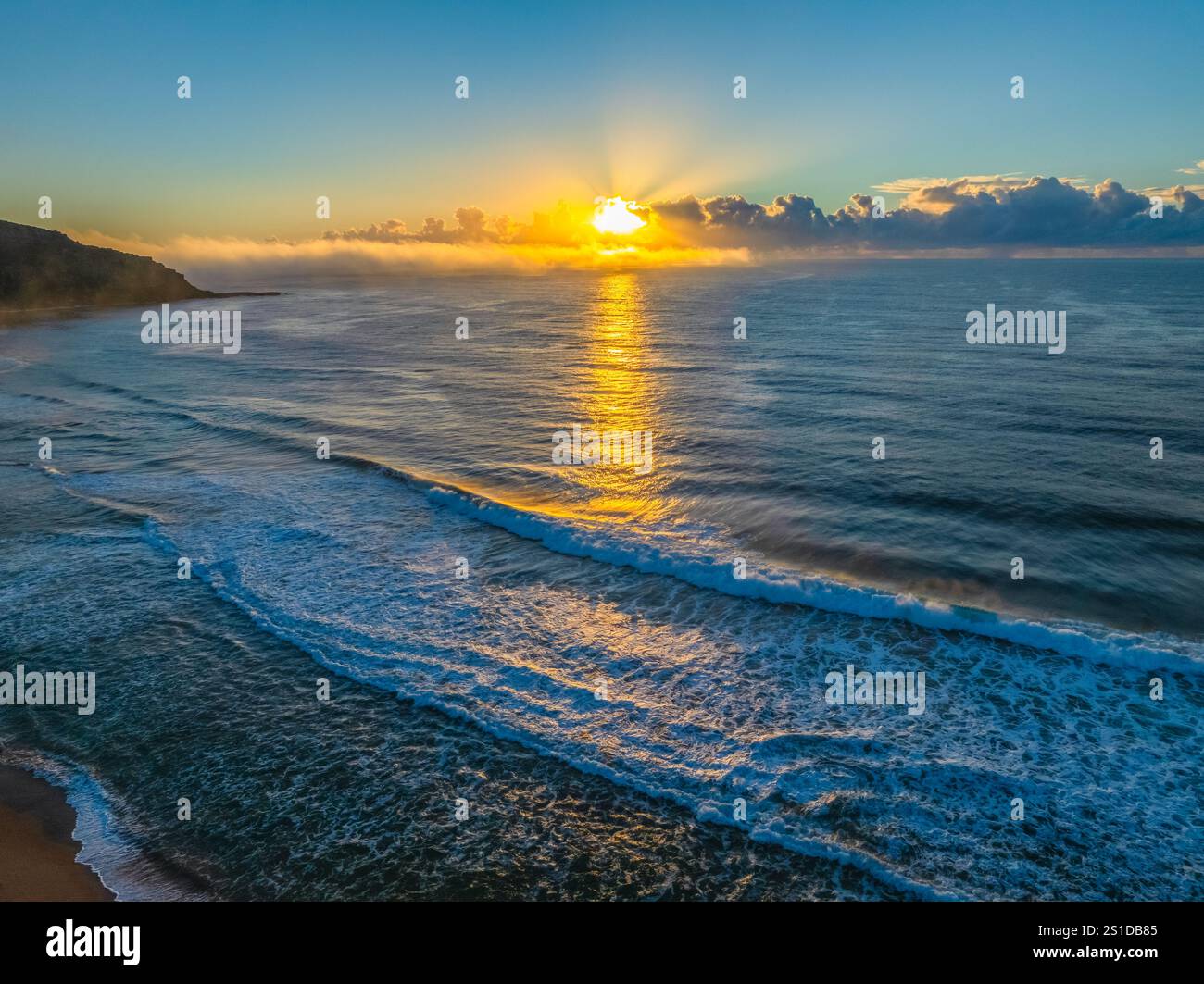 Aerial sunrise views with low cloud bank and fog rolling over the water ...