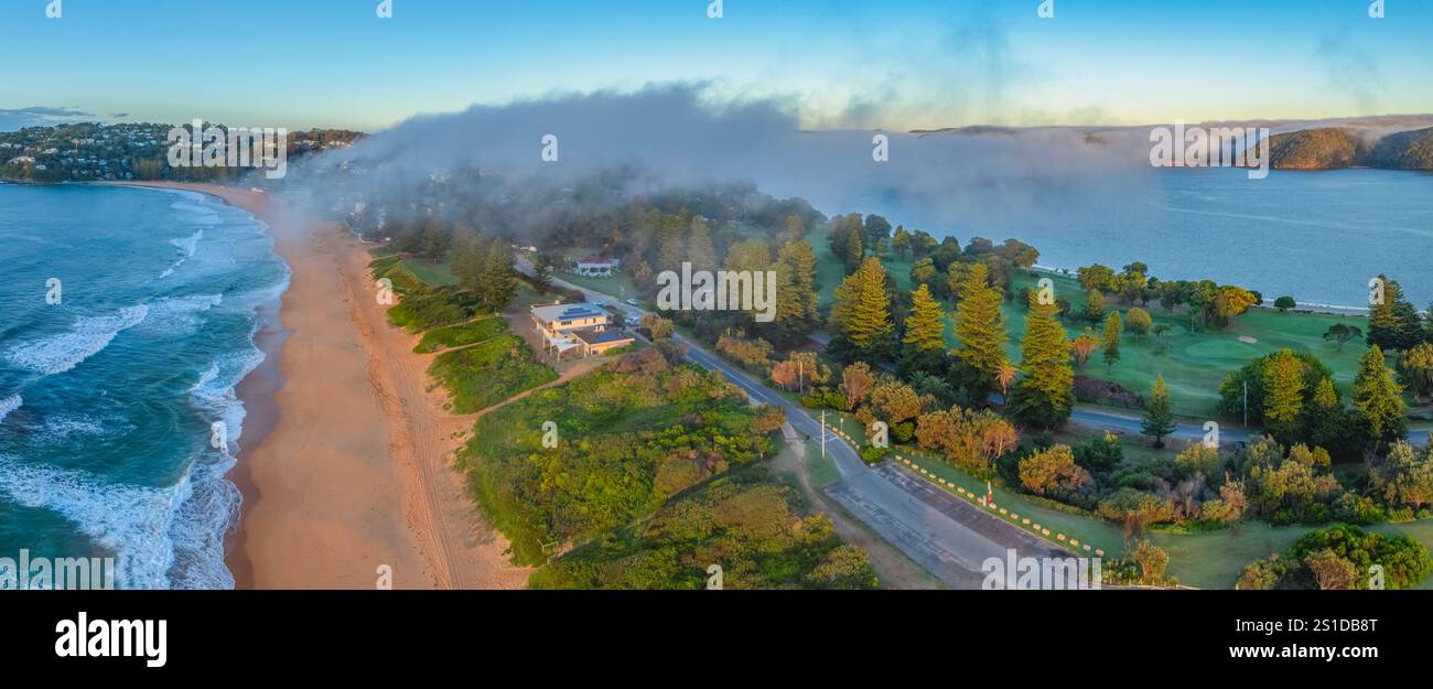 Aerial sunrise views with low cloud bank and fog rolling over the water ...