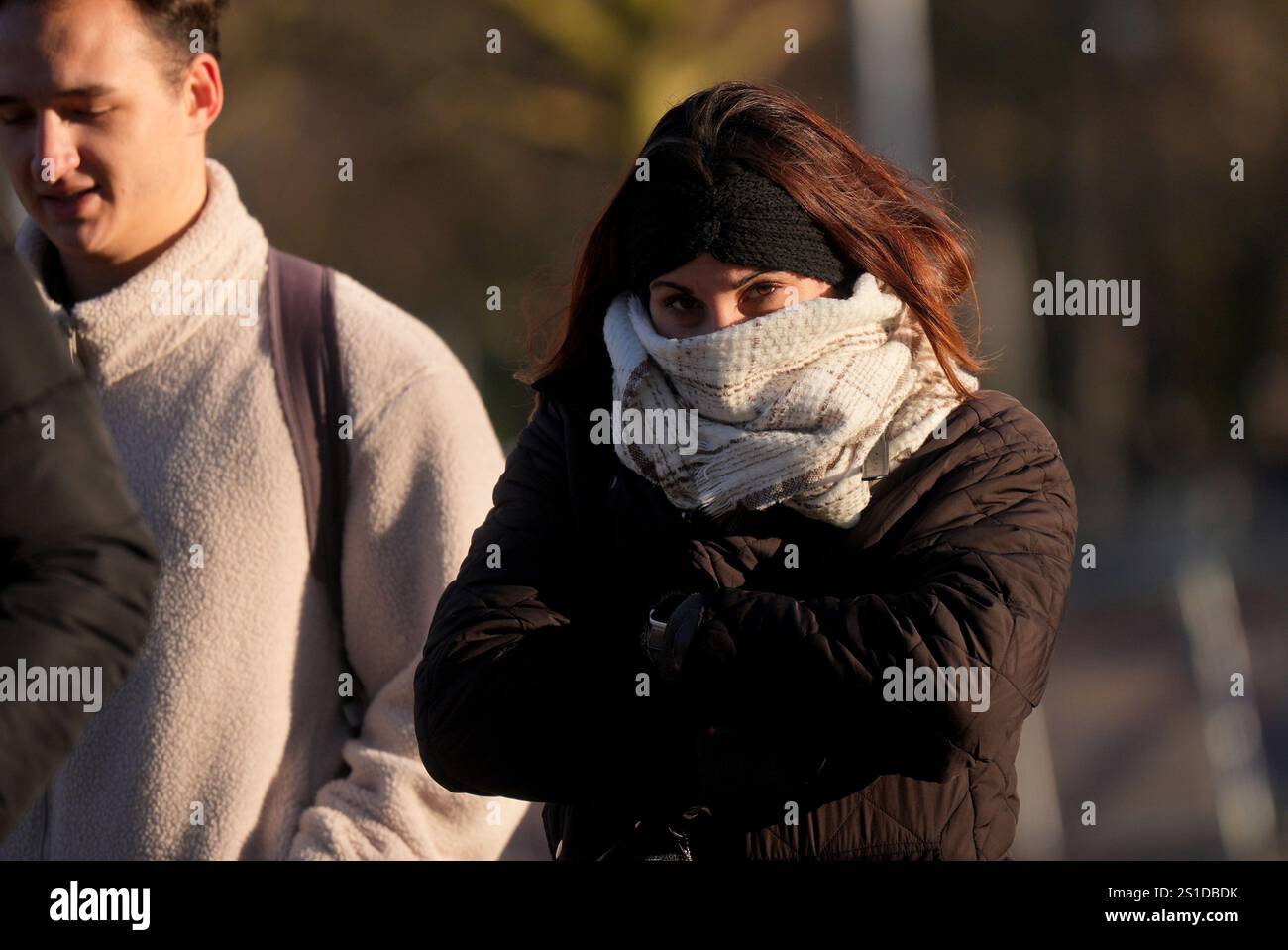 A woman braves the cold walking through Green Park in Central London ...
