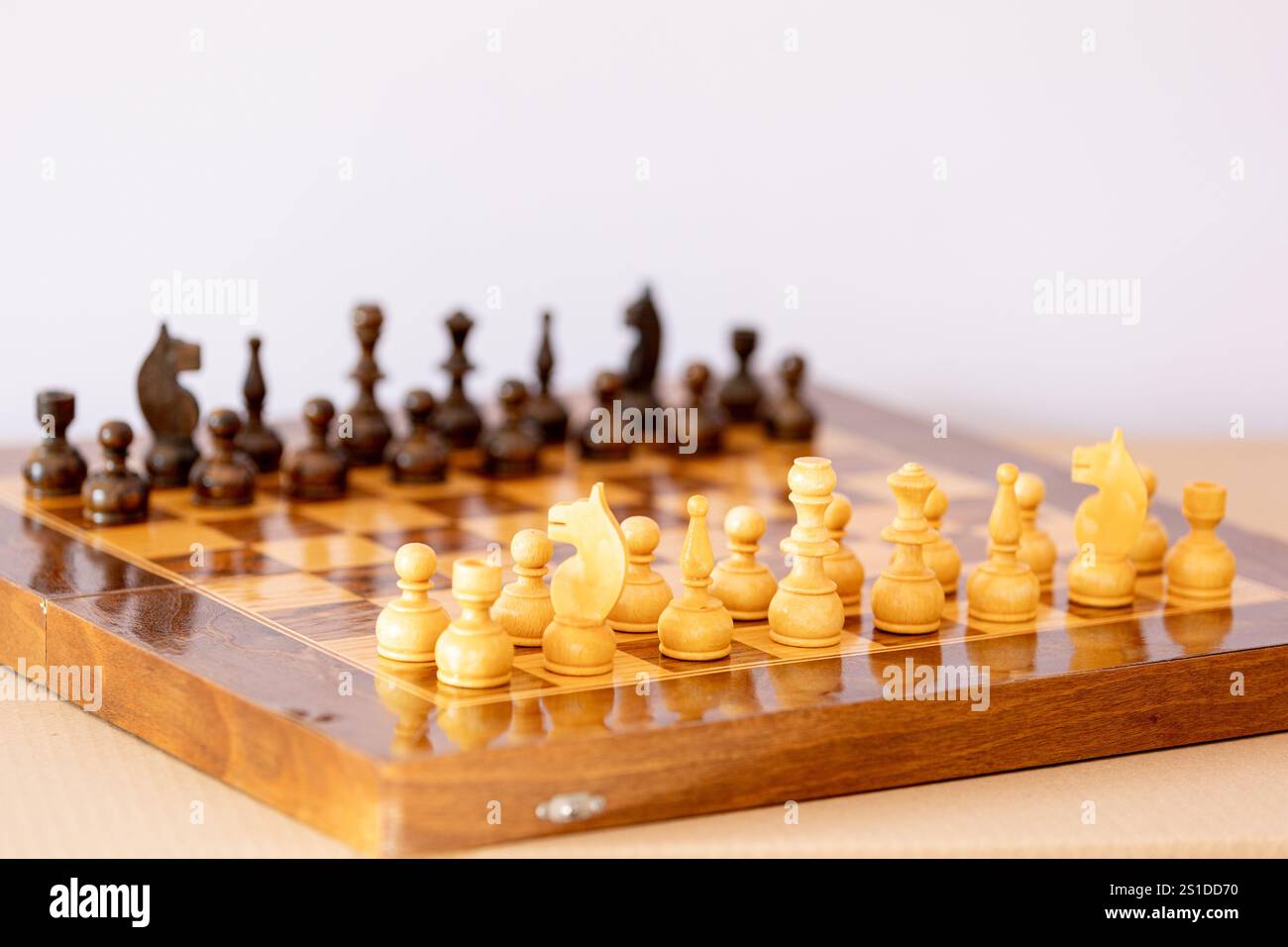 Wooden chess pieces on the chessboard. Intellectual game. White figures ...