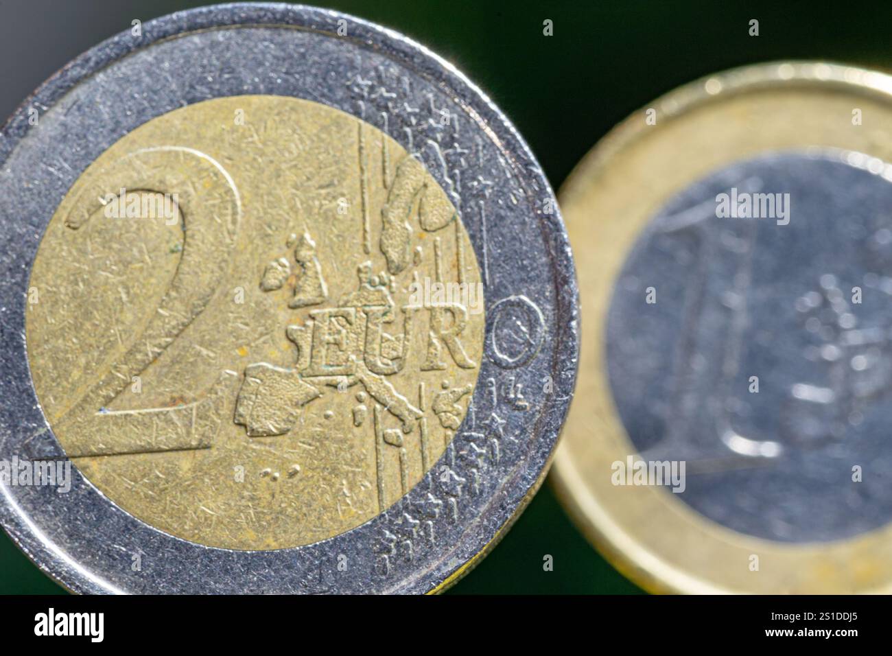 2 euro coin face with 1 euro coin face blurred in the background Stock ...