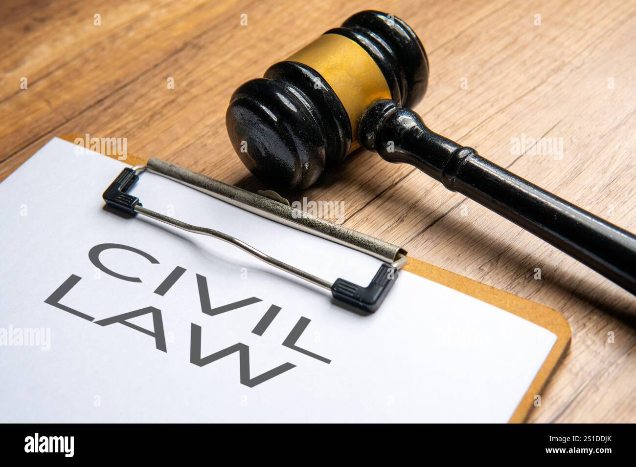 A gavel and a clipboard with the words "Civil Law" written on it. Law ...
