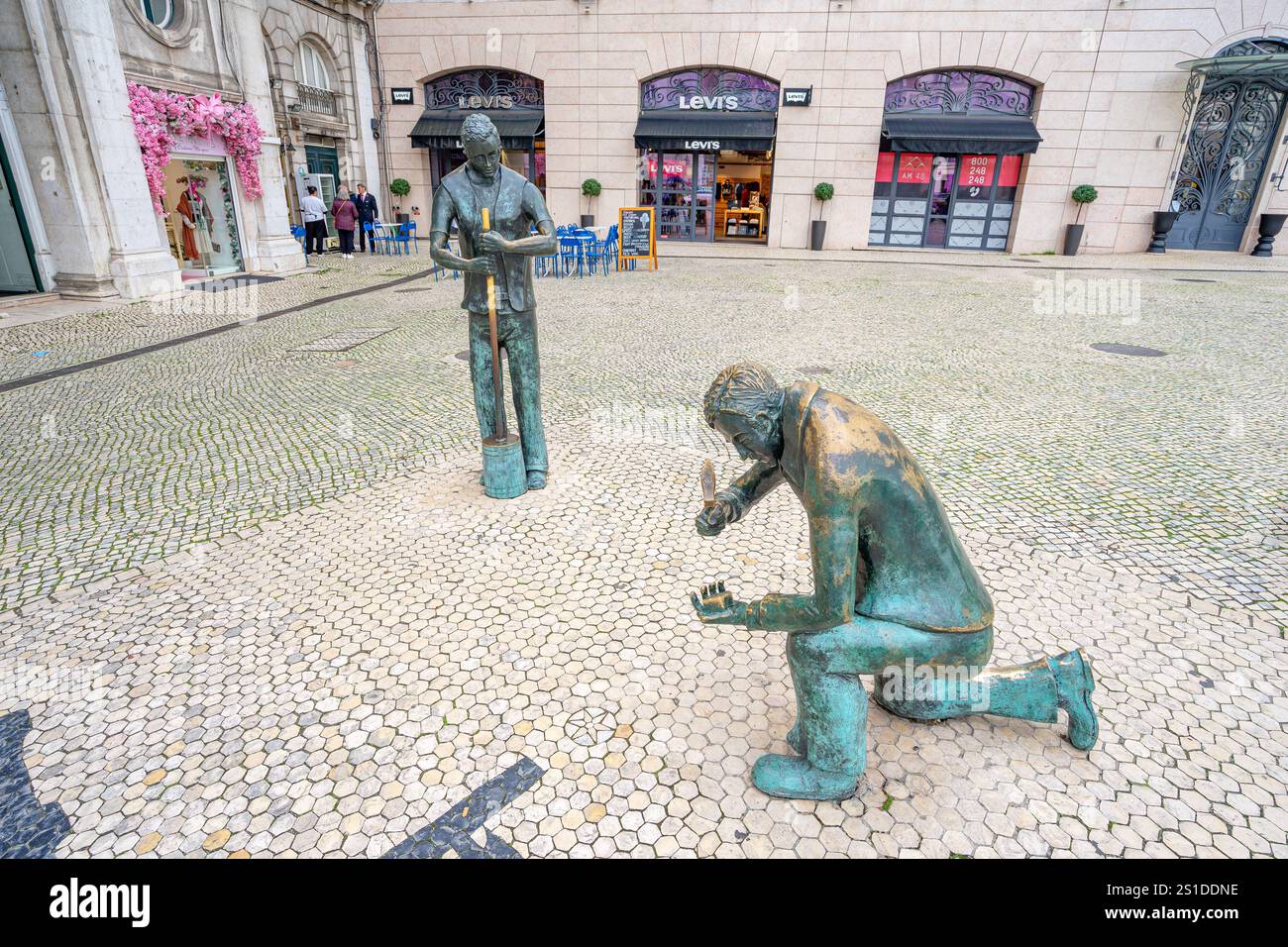 Two metal statues in honor of the pavers who build the ground we walk ...