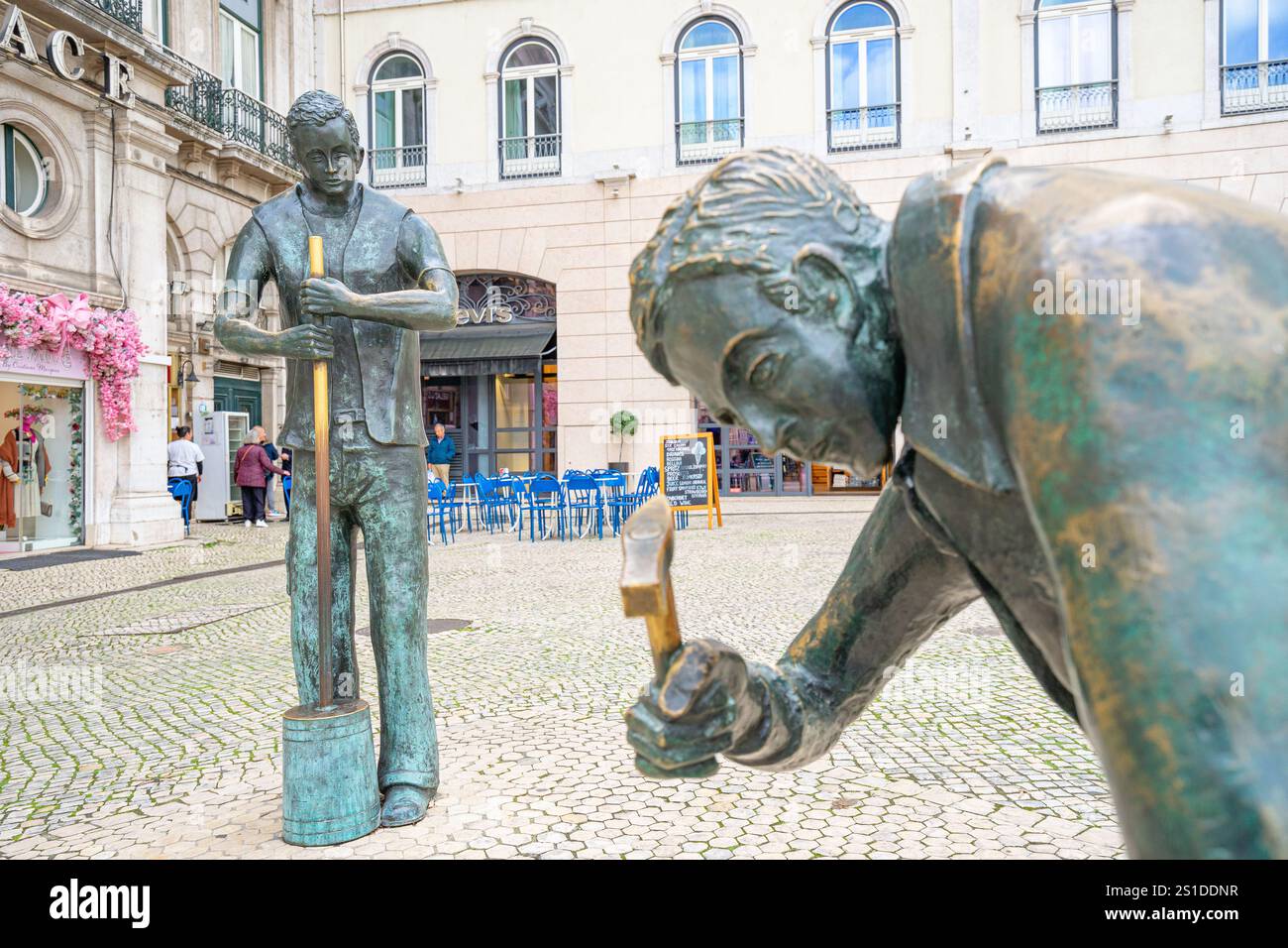 Two metal statues in honor of the pavers who build the ground we walk ...