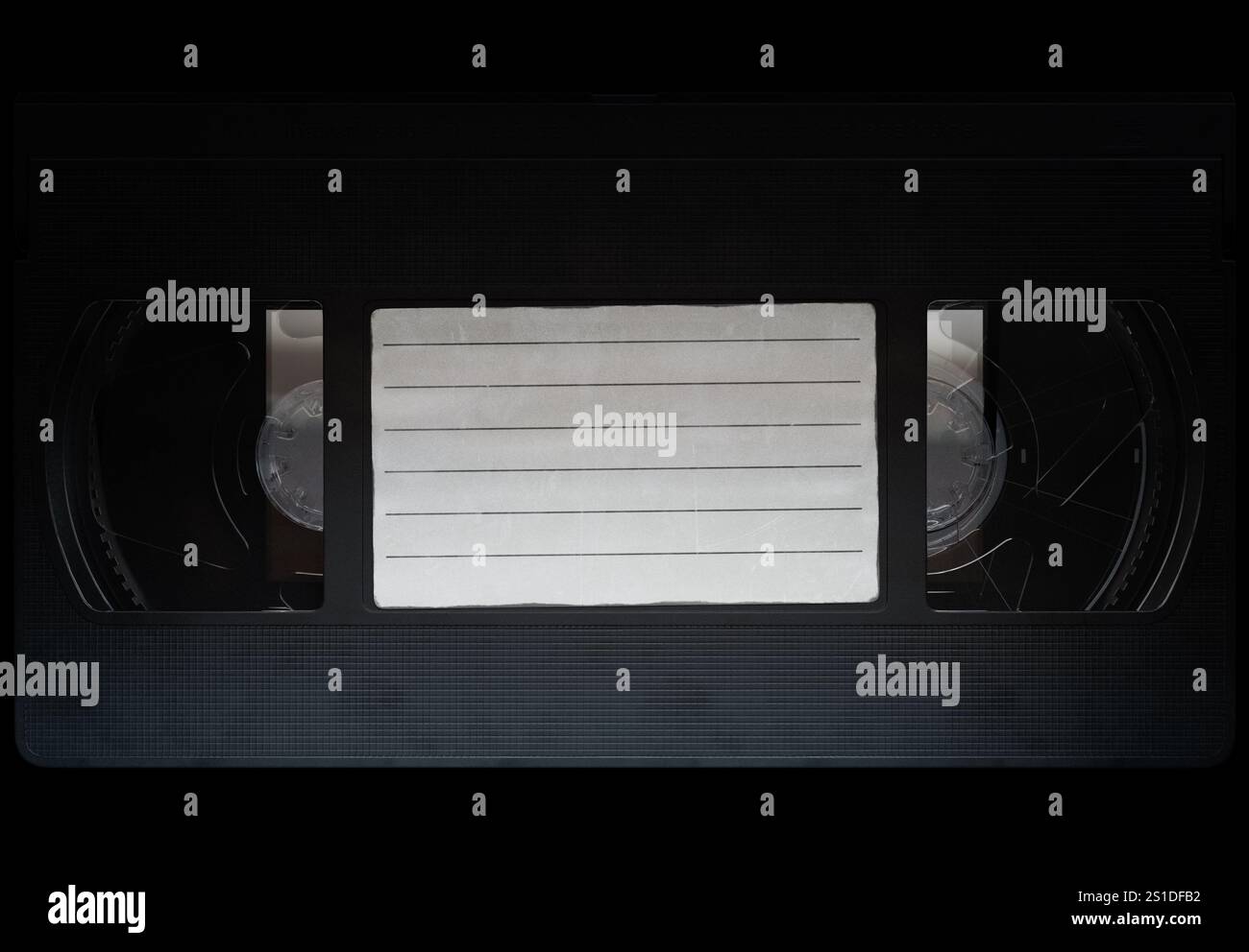 A closeup of a black video cassette analog tape VHS cassette on an ...