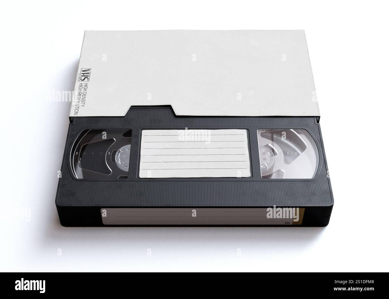A closeup of a black video cassette analog tape VHS cassette and a ...