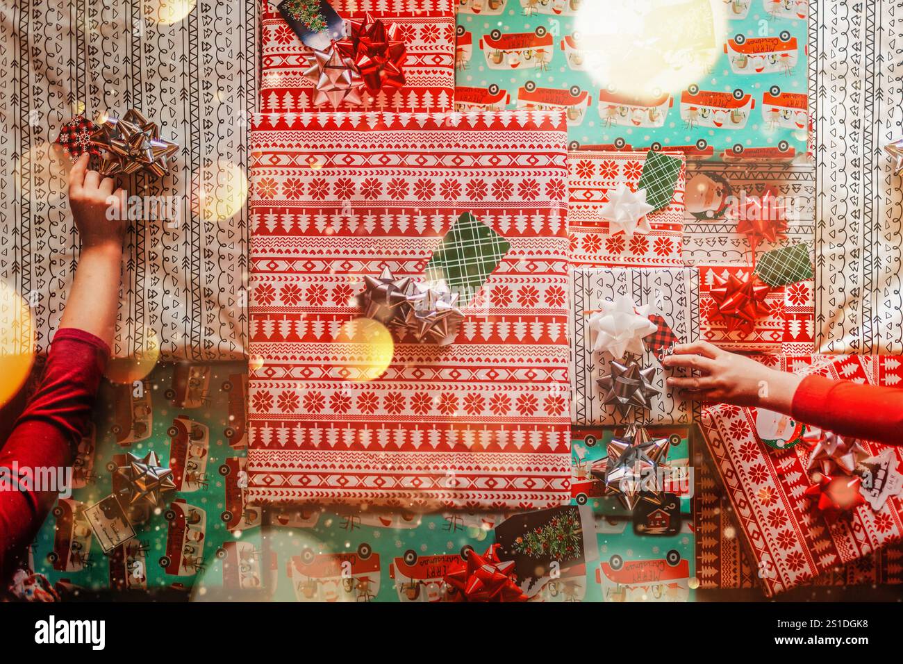 Festive Gift Giving with hands reaching for presents Stock Photo - Alamy