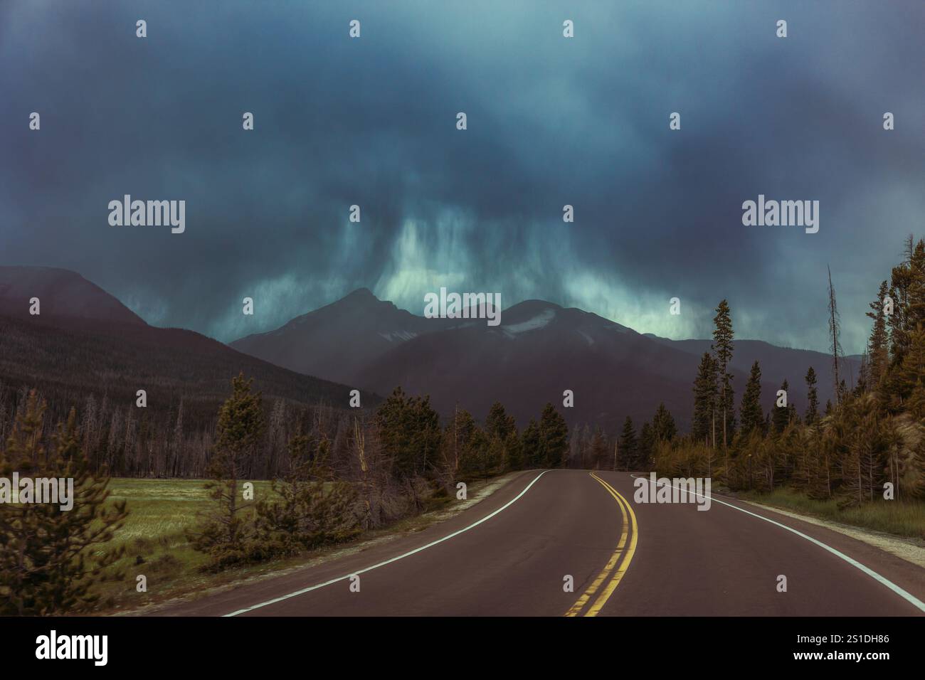 Road leading to Rain Falling on Rocky Mountains in Colorado Stock Photo ...