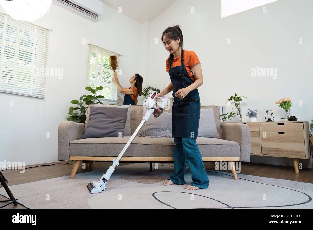 Professional Housekeeper Performing Daily Cleaning Tasks in a Modern ...
