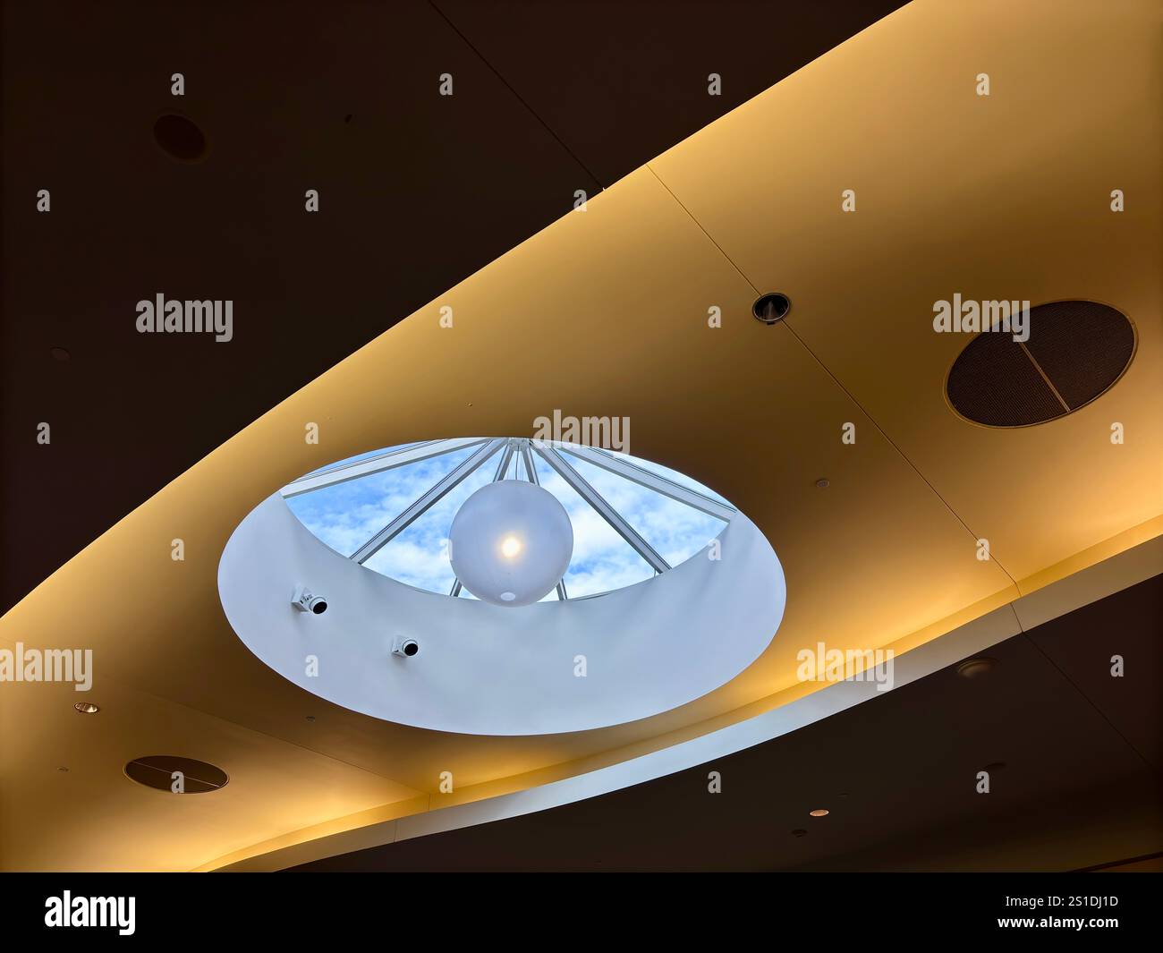Modern ceiling with skylight, circular design, warm lighting in mall ...