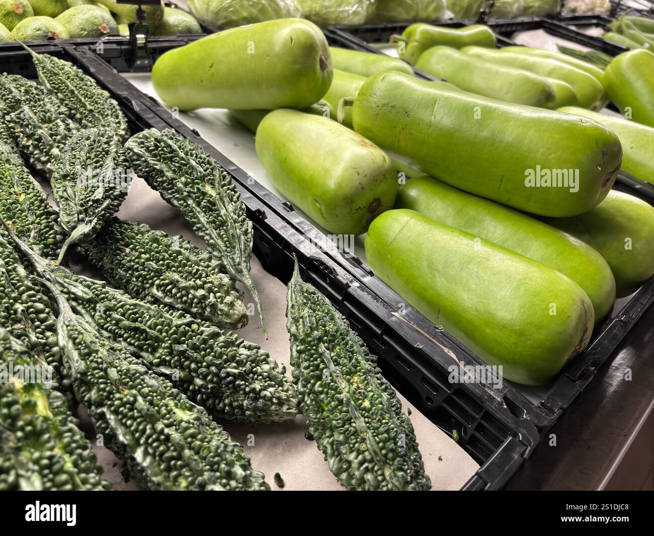 Display of fresh green bitter melons and smooth bottle gourds Stock ...