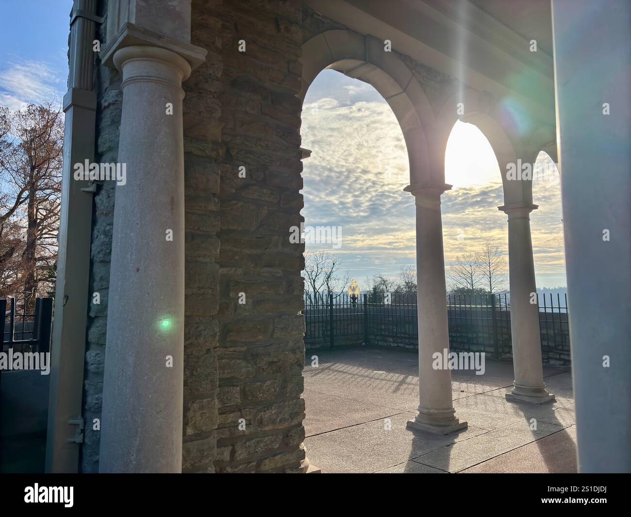 Sunlight streaming through stone arches, columns with trees Stock Photo ...