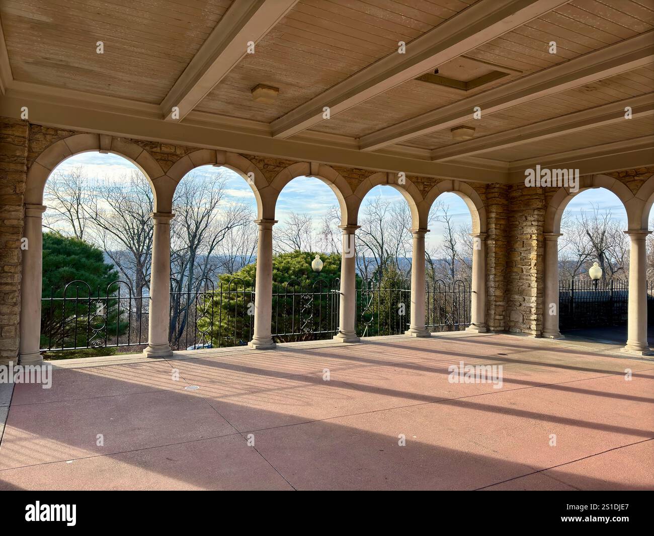 Open pavilion with stone arches, columns, and a scenic landscape view ...